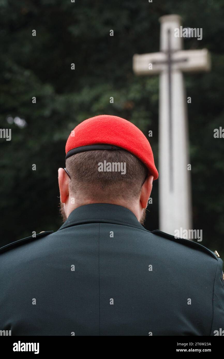 A member of the Canadian armed forces wearing a red beret in front of ...