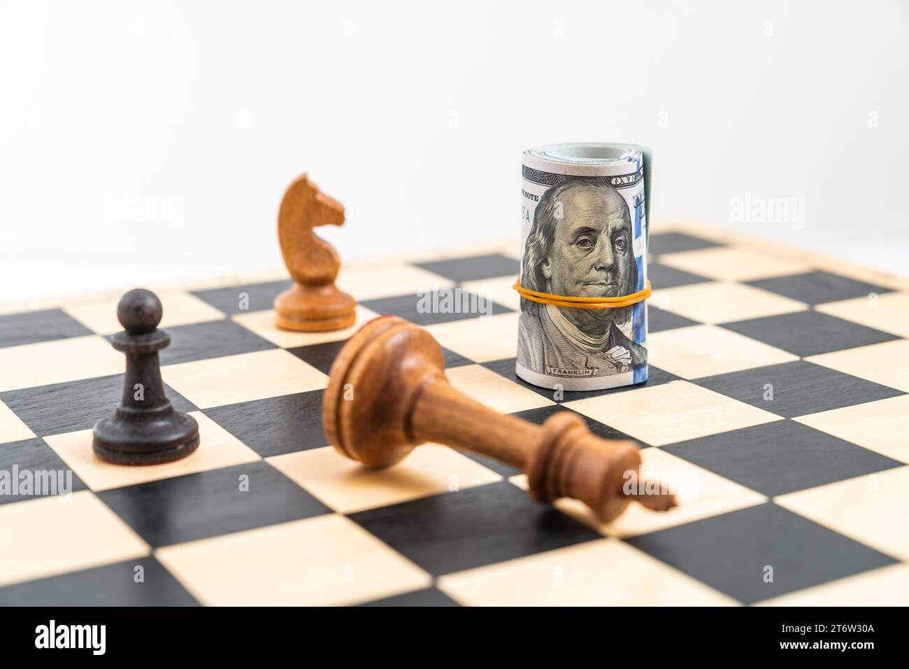 Chess game and rolled dollar bills as chess piece, black pawn and white ...