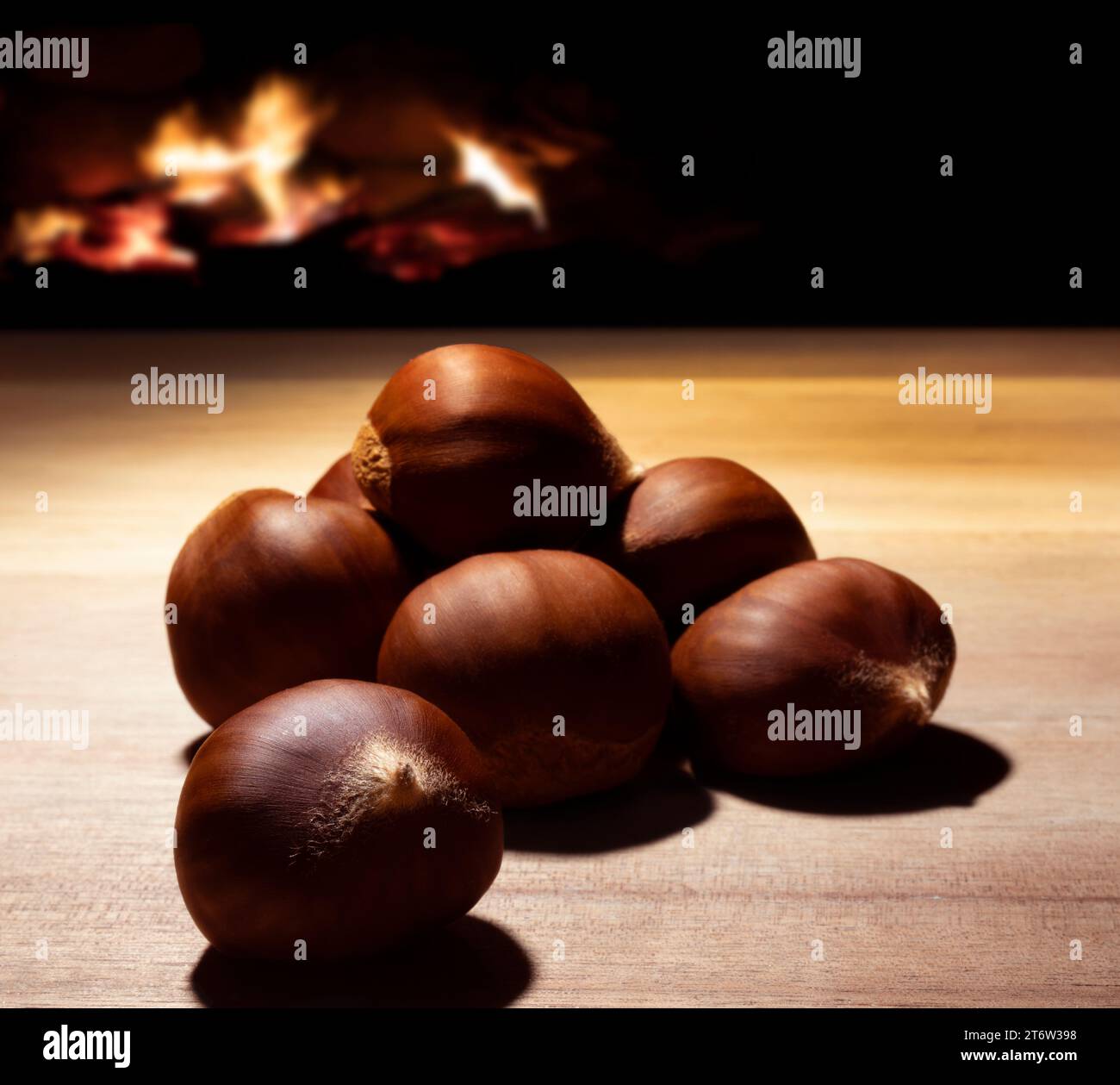Holiday chestnuts ready to roast with an open fire behind Stock Photo - Alamy