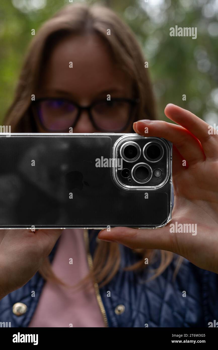 Berlin, Germany October 30 2023 Woman covering face with mobile phone ...