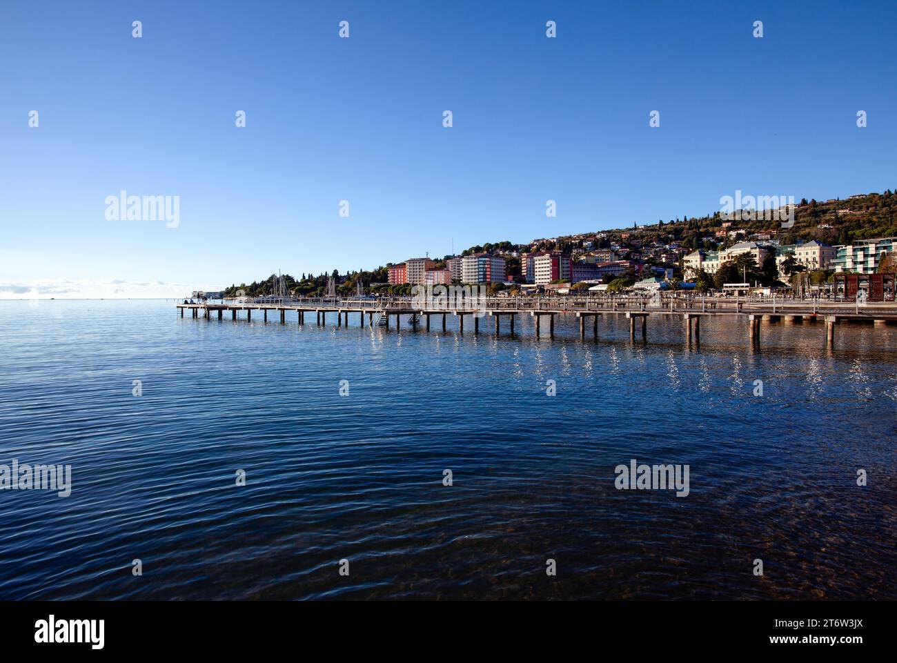 Long wooden pier in front of the coastal town (Portoroz, the Port of ...