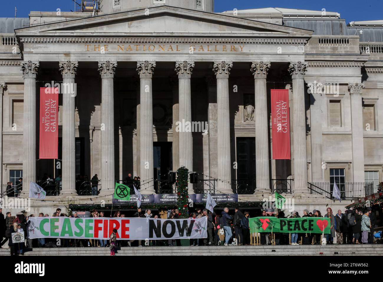 Large banners reading ‘Peace’ and ‘Cease fire Now’ provide a backdrop ...
