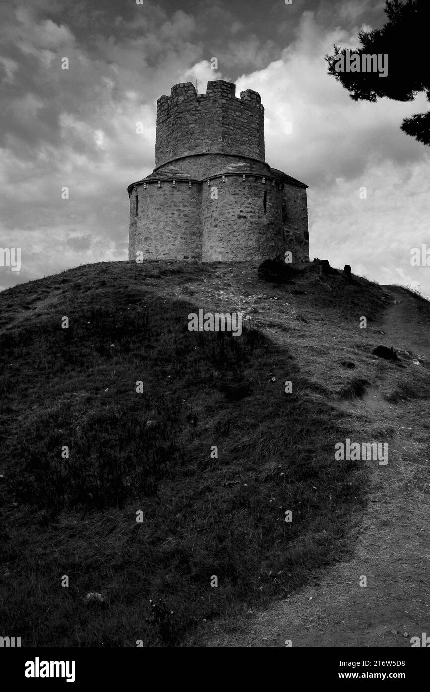 Monochrome photograph. Fortress-like church of stone rubble, the Church ...