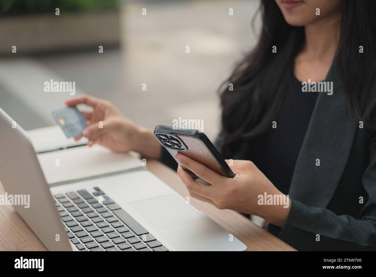 A person using a payment card to pay online Stock Photo - Alamy
