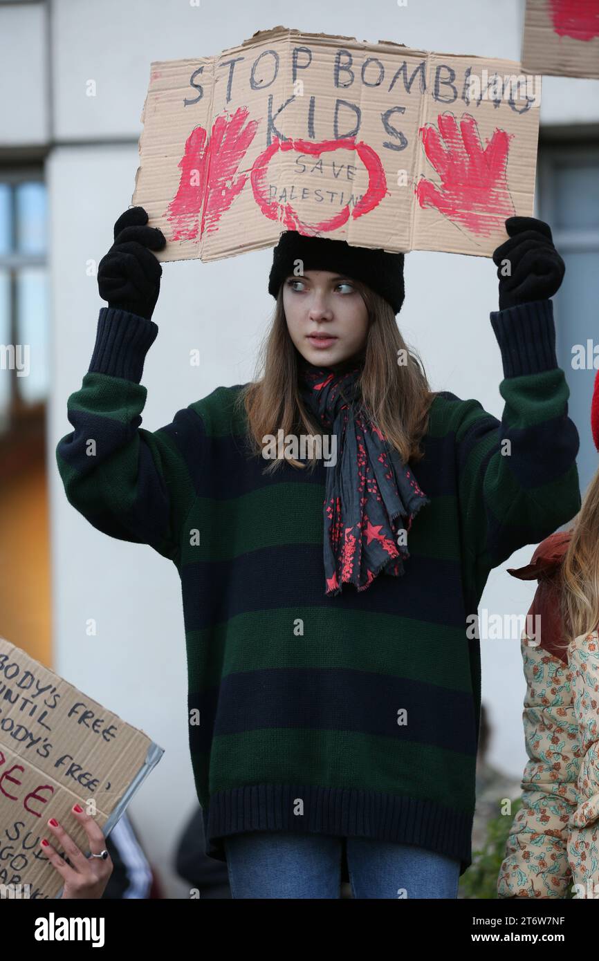 A young protester holds up a placard saying ’Stop Bombing Kids as the ...