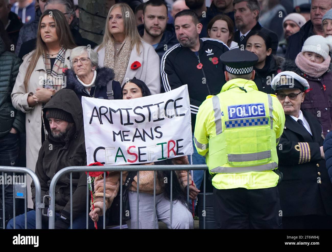 A woman holds a banner reading "Armistice means ceasefire" during a ...