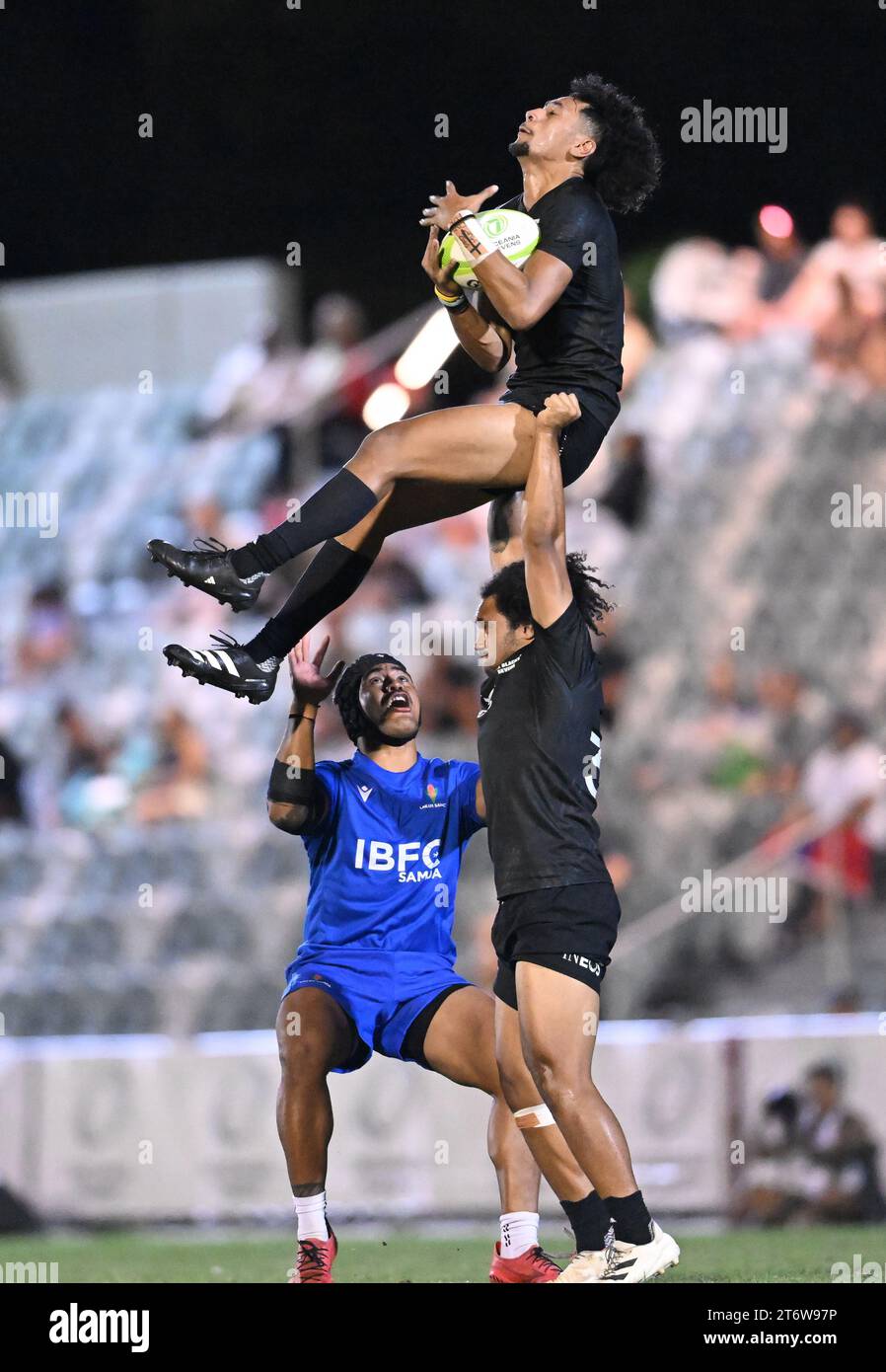 Codemeru Vai (top) of New Zealand is lifted by team mate Fehi Fineanganofo (bottom) to catch the ...