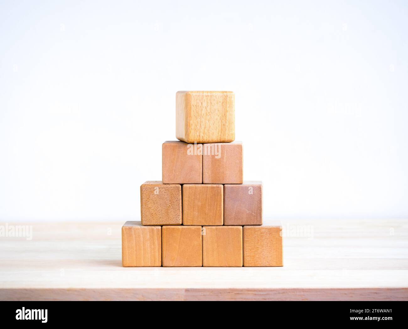 Empty blank wooden cube blocks build pyramid shape with the big one on ...