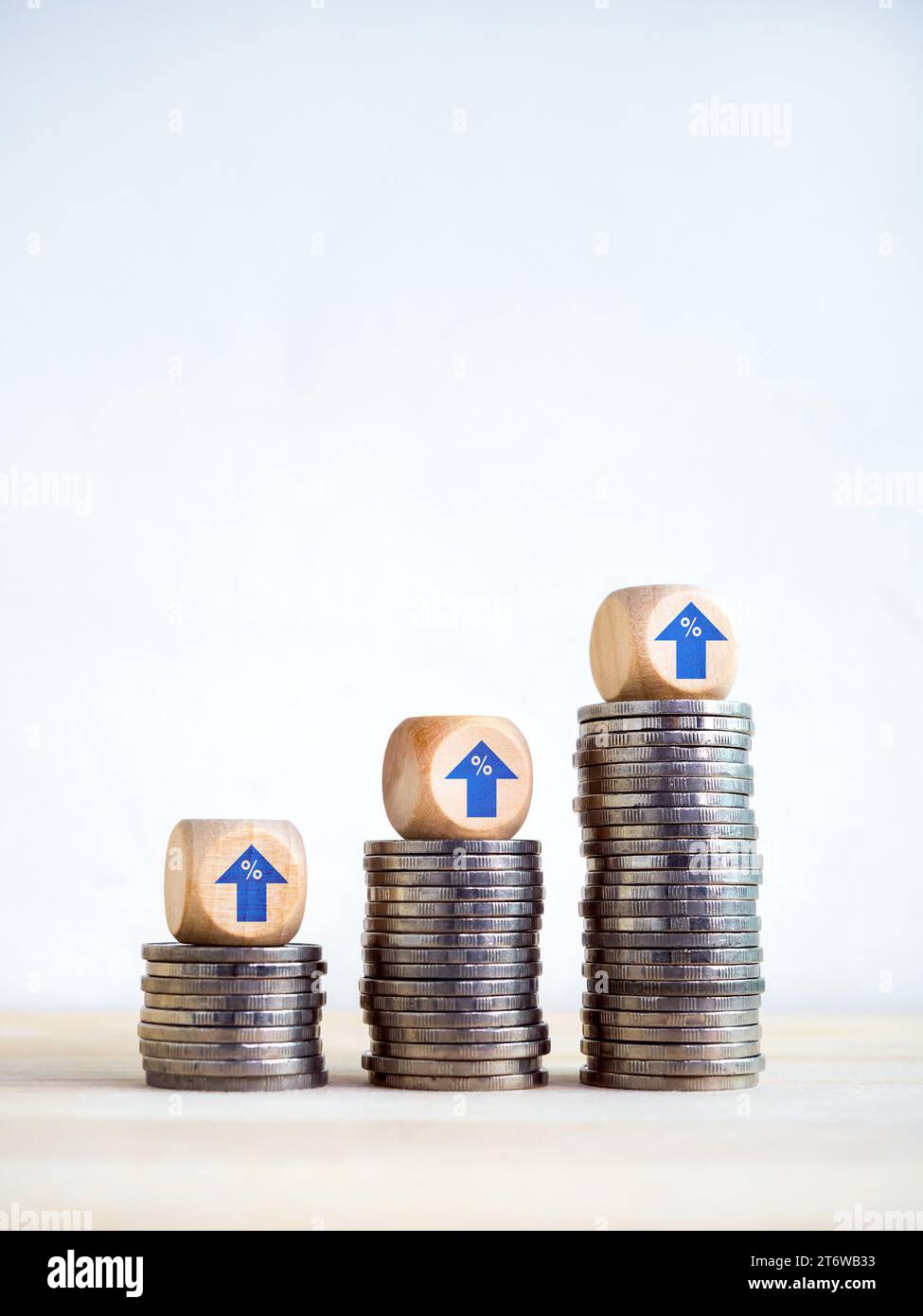 Blue arrow with percentage icons on wooden cube blocks on business coin ...