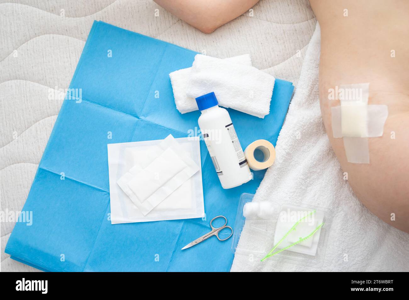 View of Body lying wounded with gauze on hip and Aid Kit utensils ...