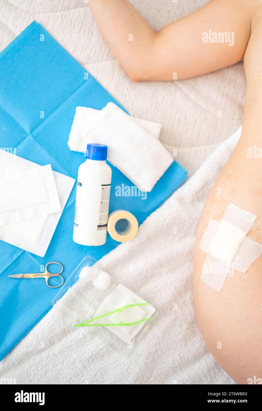 View of Body lying wounded with gauze on hip and Aid Kit utensils ...