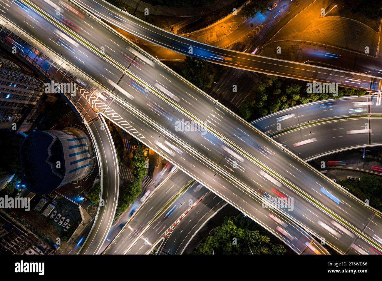 Aerial view of busy nighttime city intersection featuring multiple ...