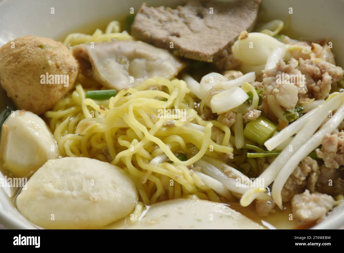 boiled Chinese yellow egg noodles with entrails and fish ball in soup ...