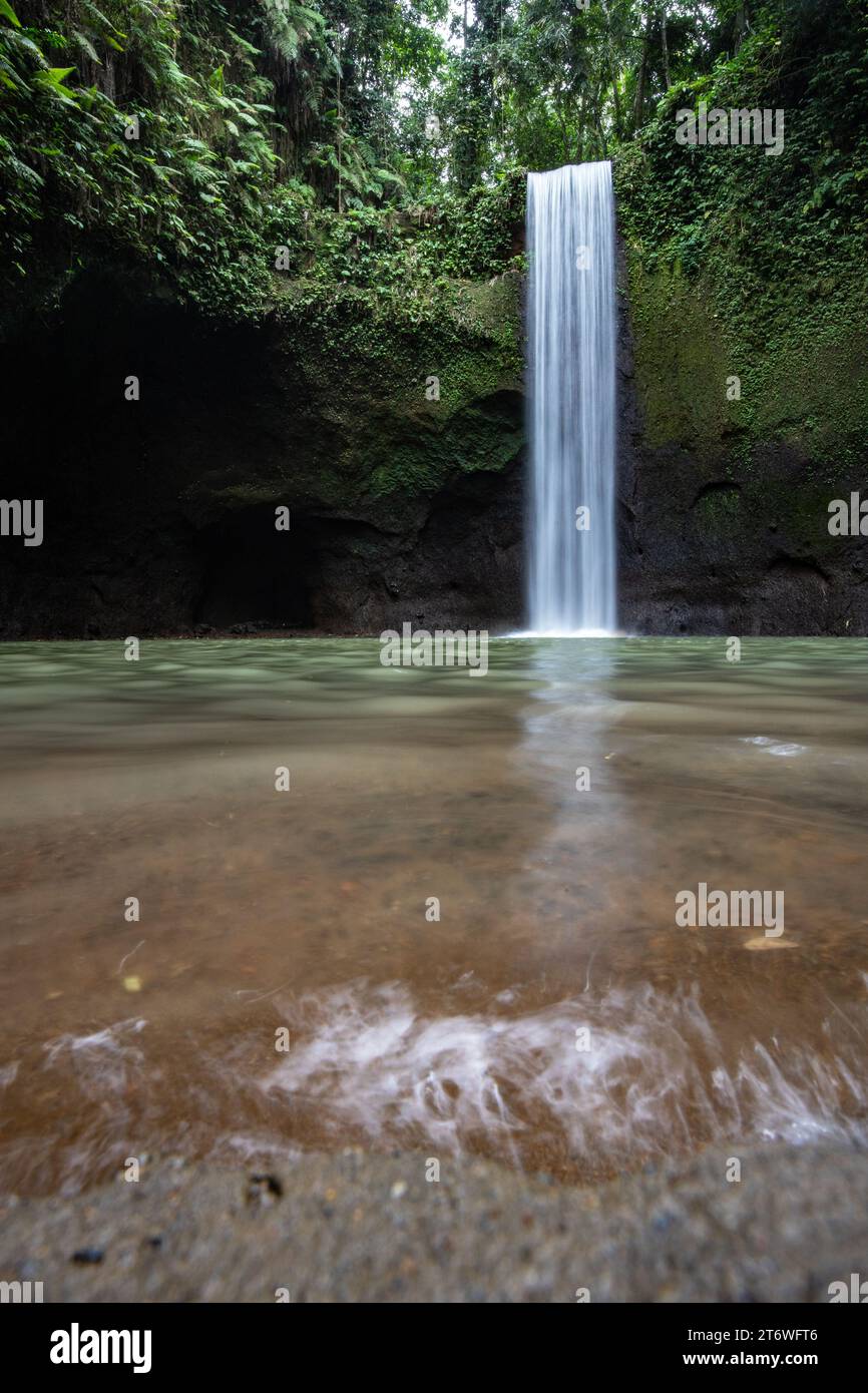 Tibumana Waterfall a small wide waterfall in a green gorge. The river ...