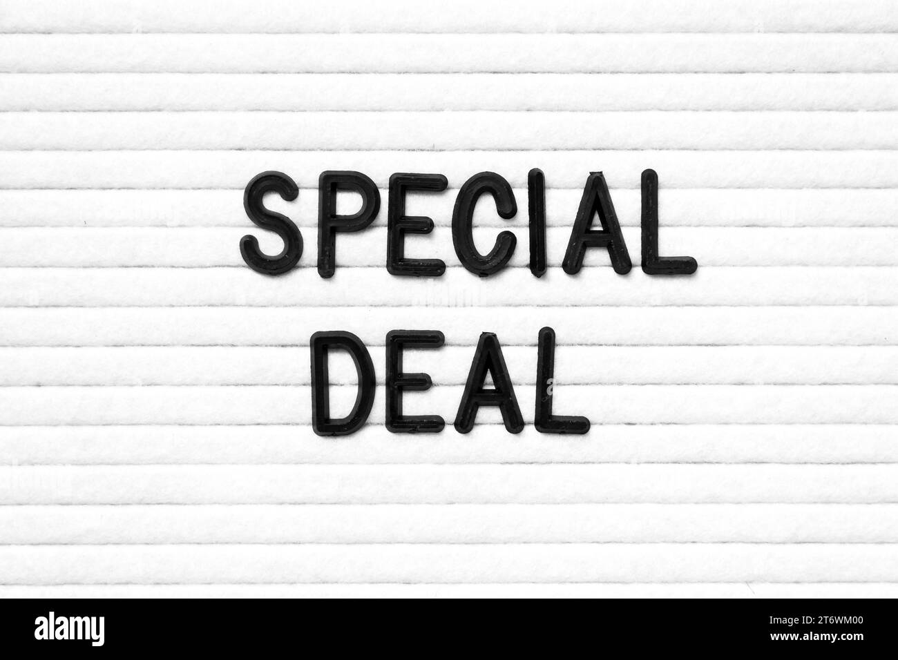 Black color letter in word special deal on white felt board background ...