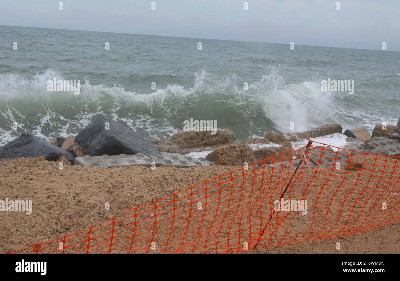 Spray shoots up from large wave hitting make-shift Tank Block Flood ...