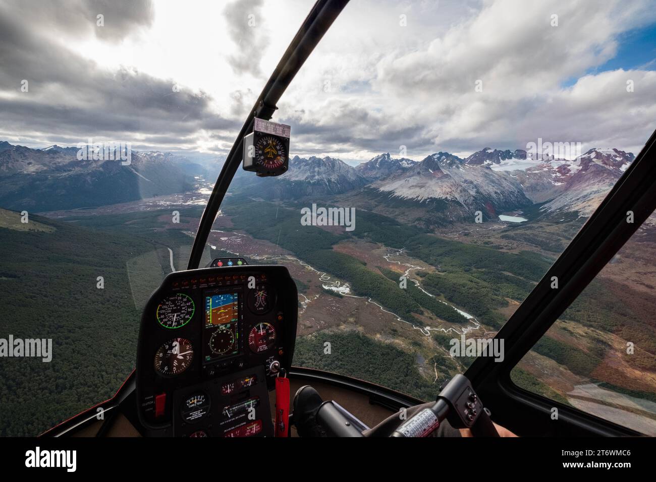 Aerial view of the mountains, rivers and valleys from the cabin of a ...