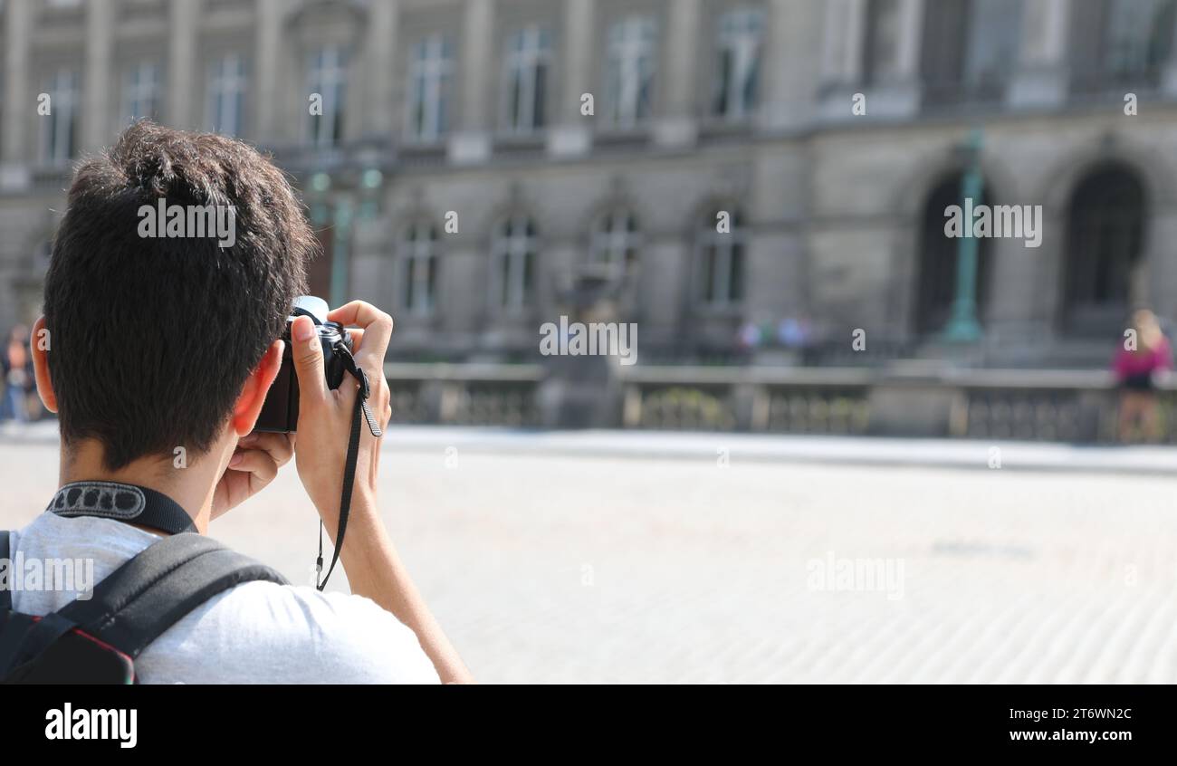 photographer with digital camera taking photographs at ancient building ...