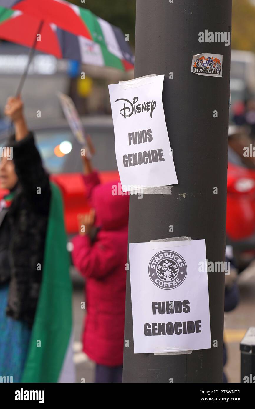 Anti Disney and Starbucks posters at the Pro Palestine March in Cardiff ...