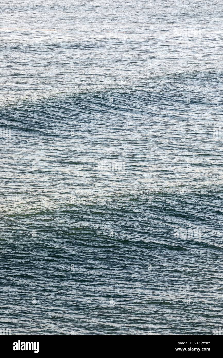 Unbroken waves passing through the ocean surface Stock Photo - Alamy