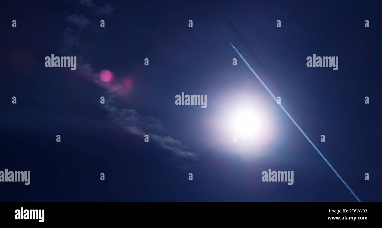 Dreamy vision of a jet airplane with a strikingly defined contrail that ...