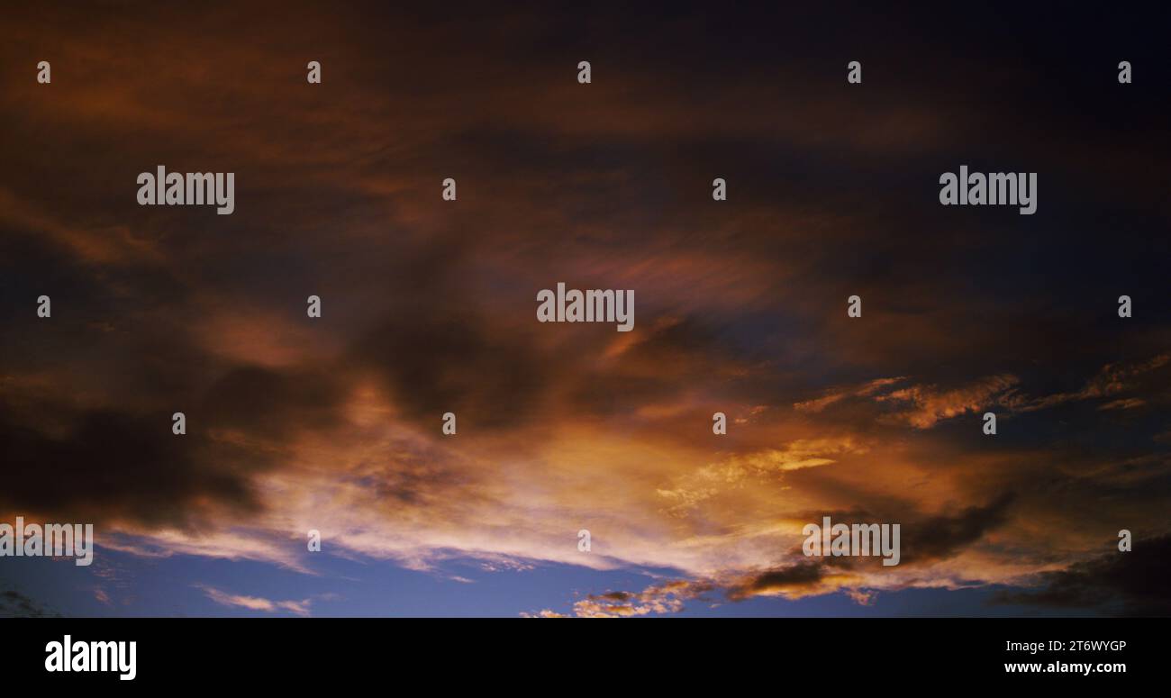 Layers of cirrus and cirrostratus clouds, drenched in color, set the ...