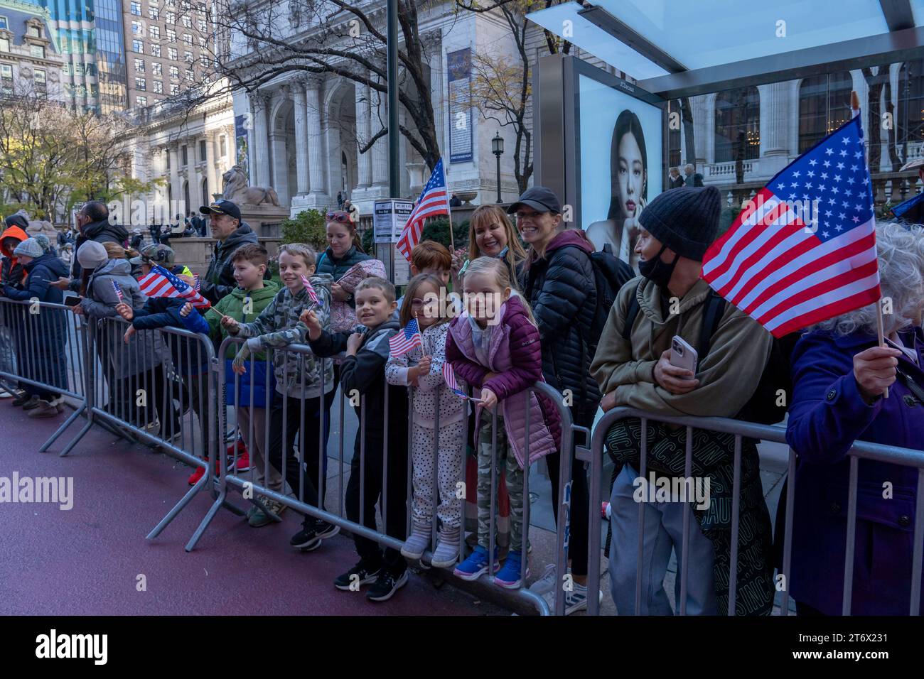 NEW YORK, NEW YORK - NOVEMBER 11: Spectators hold sign and flags in the ...