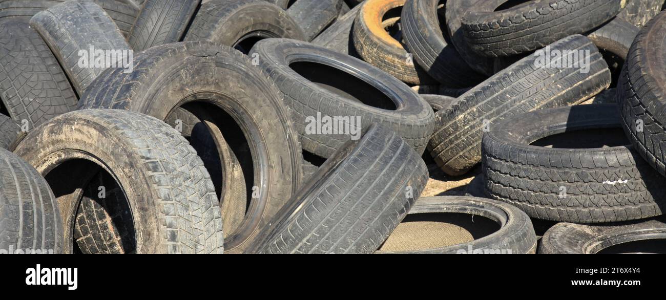 Dirty car tires at a city dump. Industrial pollution of the environment ...