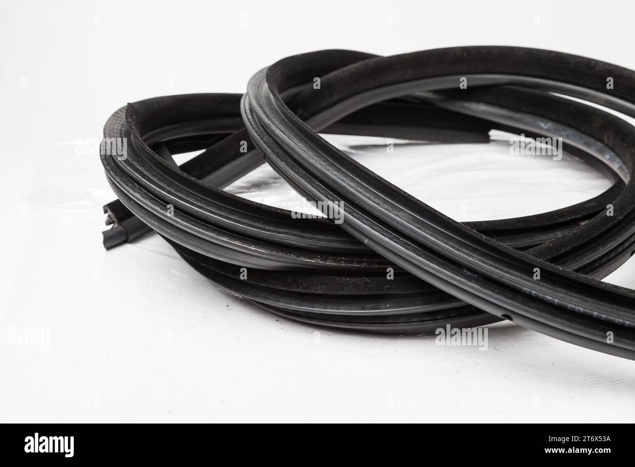 Rolled up black rubber sealant for elements of the car body, doors or ...