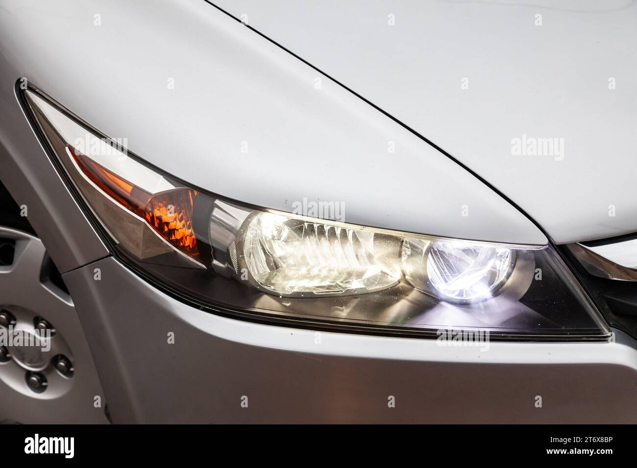 Front headlight view of car in blue color after cleaning and detailing ...