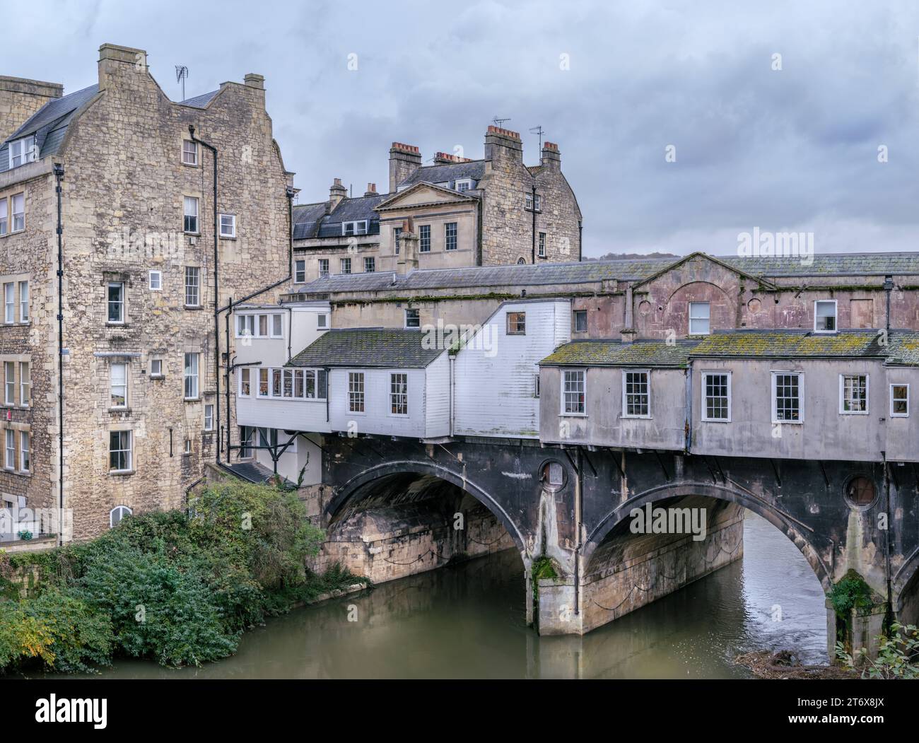 Bath, Somerset - England. Pulteney Bridge sits above the fast flowing ...
