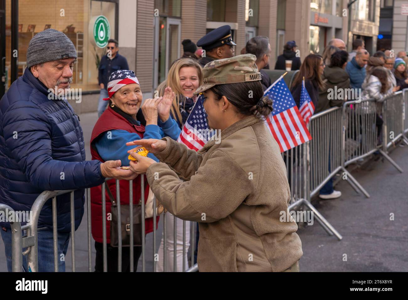 NEW YORK, NEW YORK - NOVEMBER 11: Army soldier hands out candy to ...