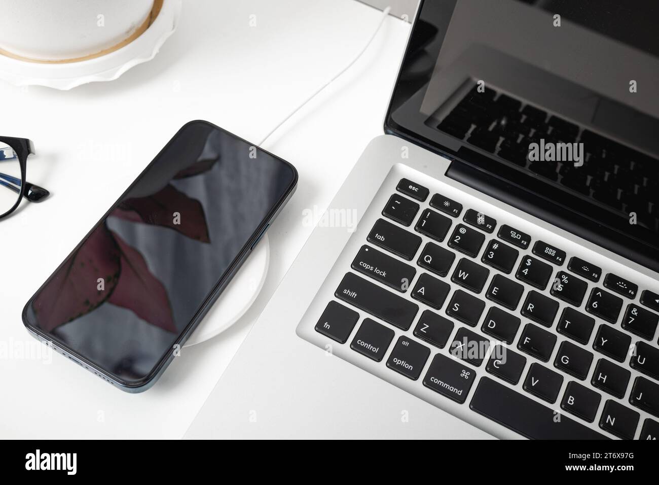 Charging smartphone battery with wireless charger device Stock Photo ...