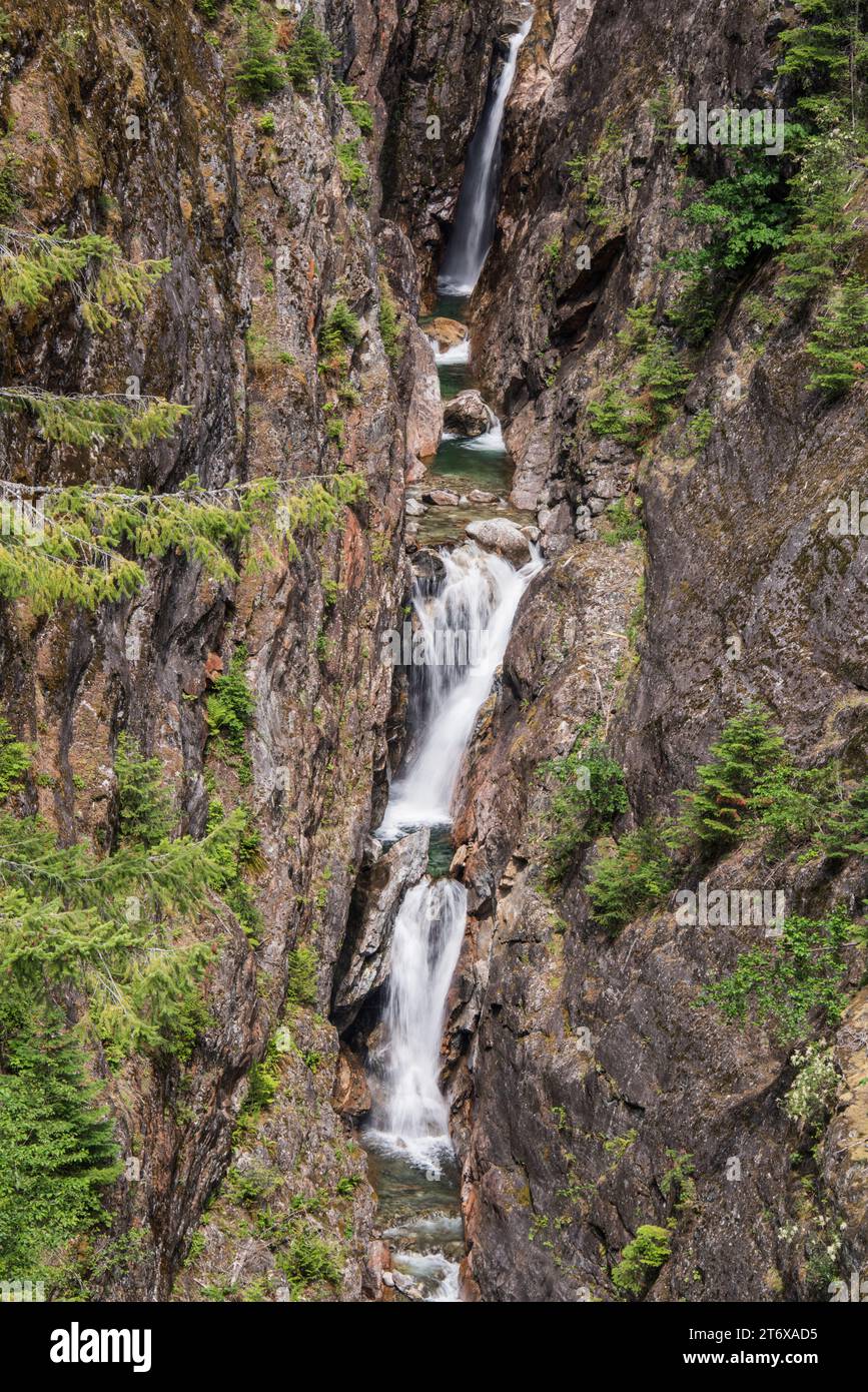 vertical format image of Gorge Creek Falls, a long beautiful waterfall ...