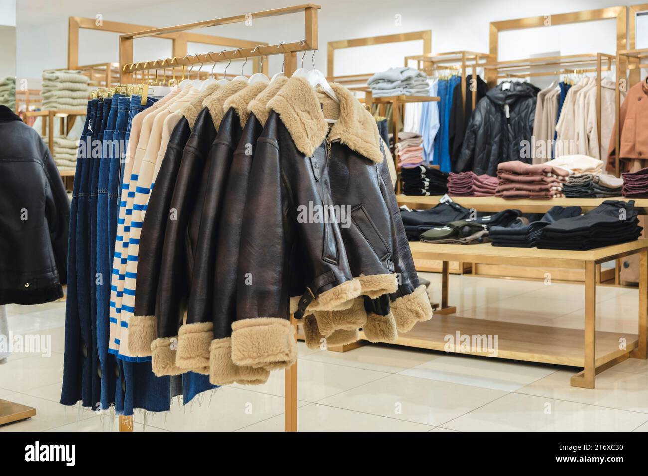 Multicolor family clothes on hangers in store Stock Photo - Alamy