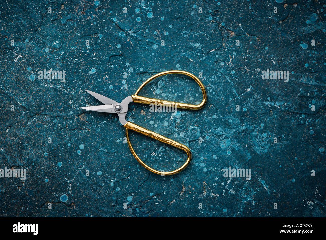 Old vintage rusty scissors isolated over vintage blue backdrop texture ...