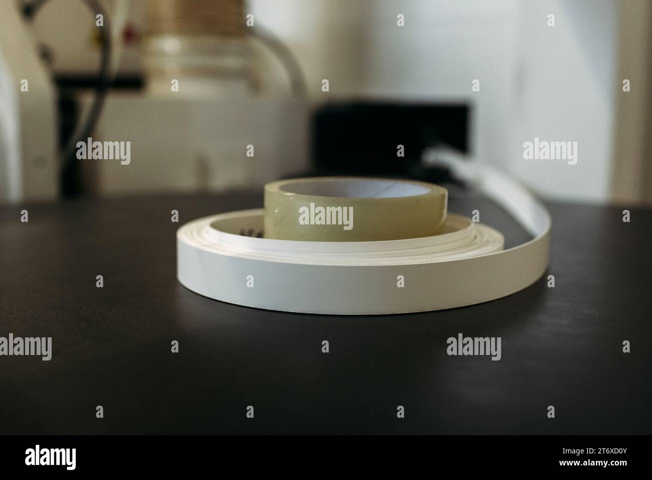 Furniture manufacture. Filling the machine with a PVC edge for edging ...