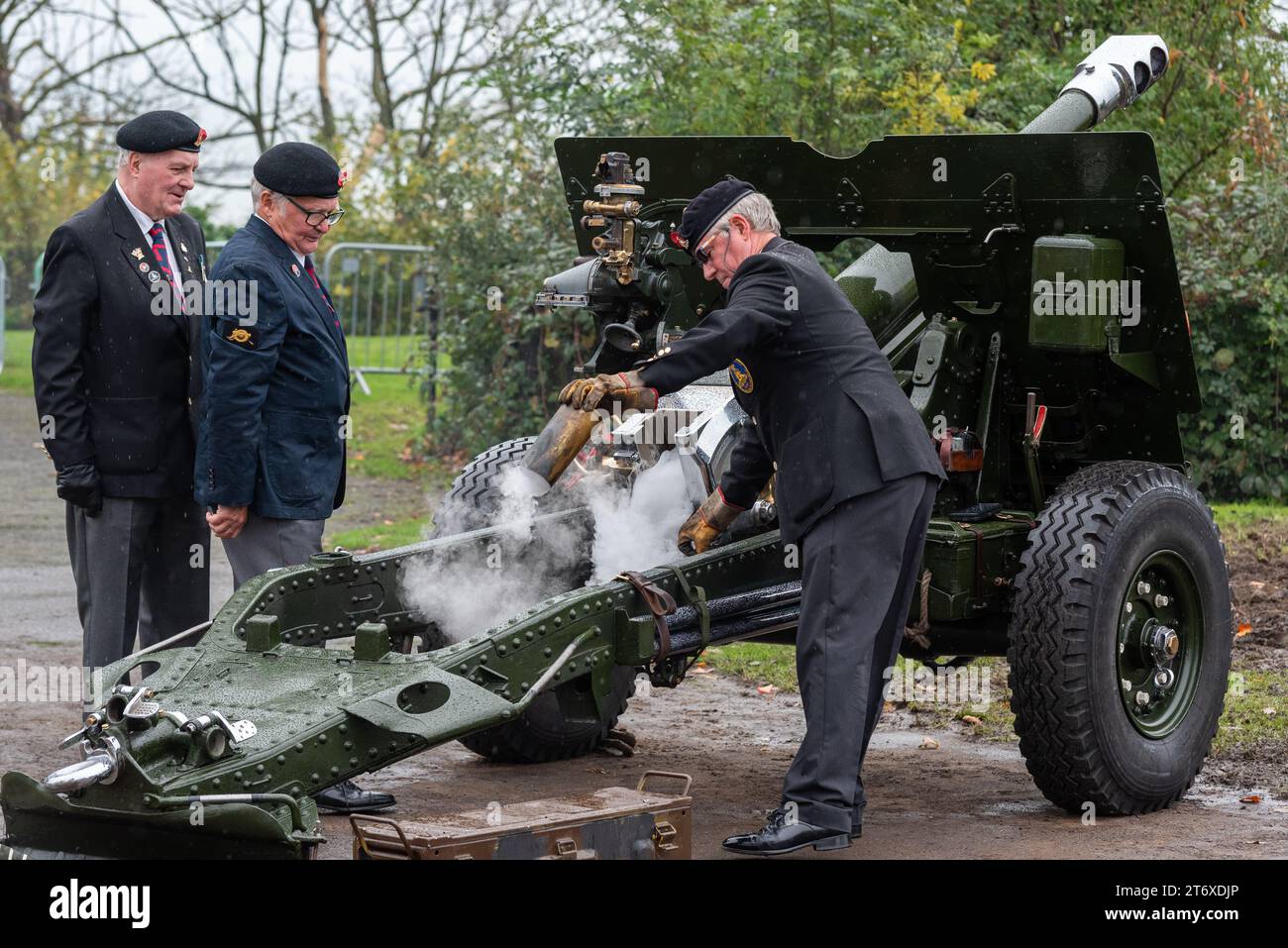 Gun crew unloading spent shell casing after gun salute. Remembrance Day ...