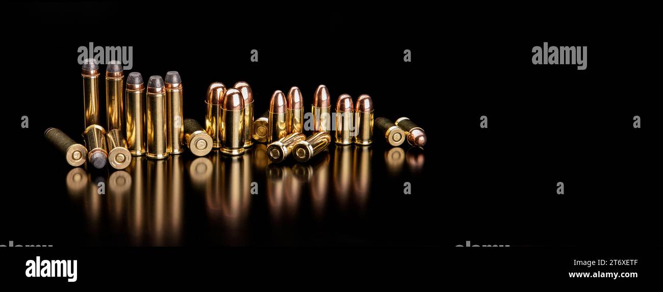 Bullet isolated on black background with reflexion. Rifle bullets close ...
