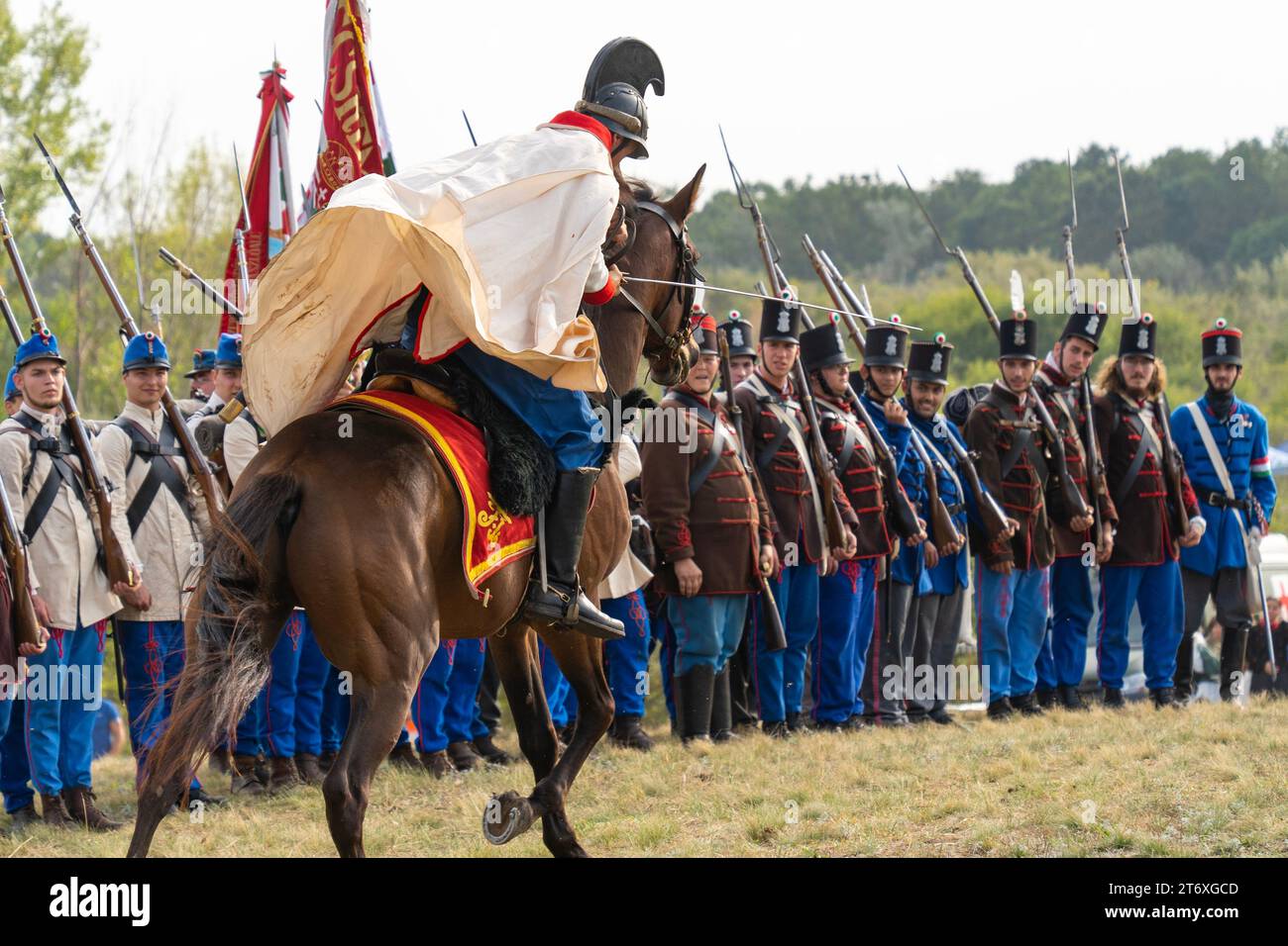 A dragoon cavalry soldier in front of a line of infantry during a ...