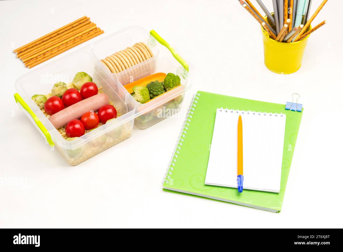 School lunchbox on table. Notebook pen, and bottle of yogurt. Yellow ...