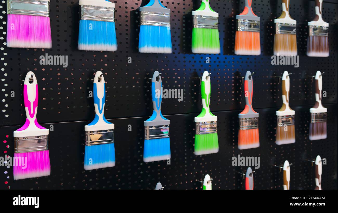 Multi-colored brushes for repairing black wall painting hang on a stand ...