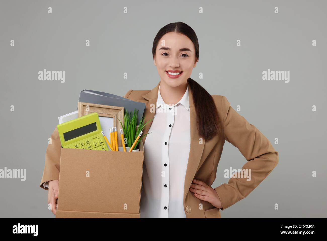 Happy unemployed woman holding box with personal office belongings on ...
