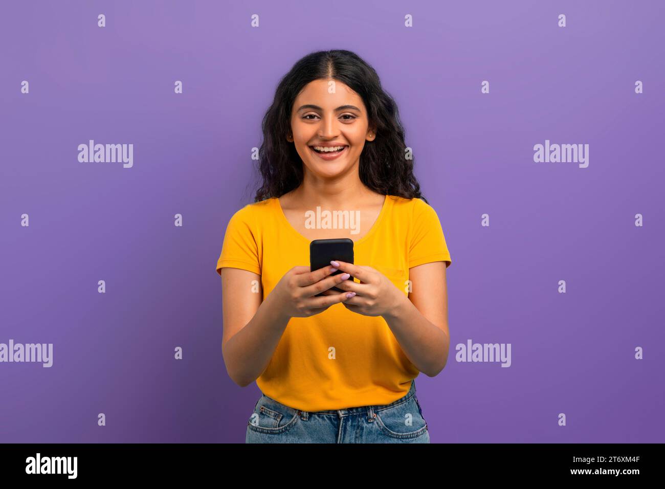 Cheerful Indian Lady Using Smartphone For Messaging With Friends Stock ...