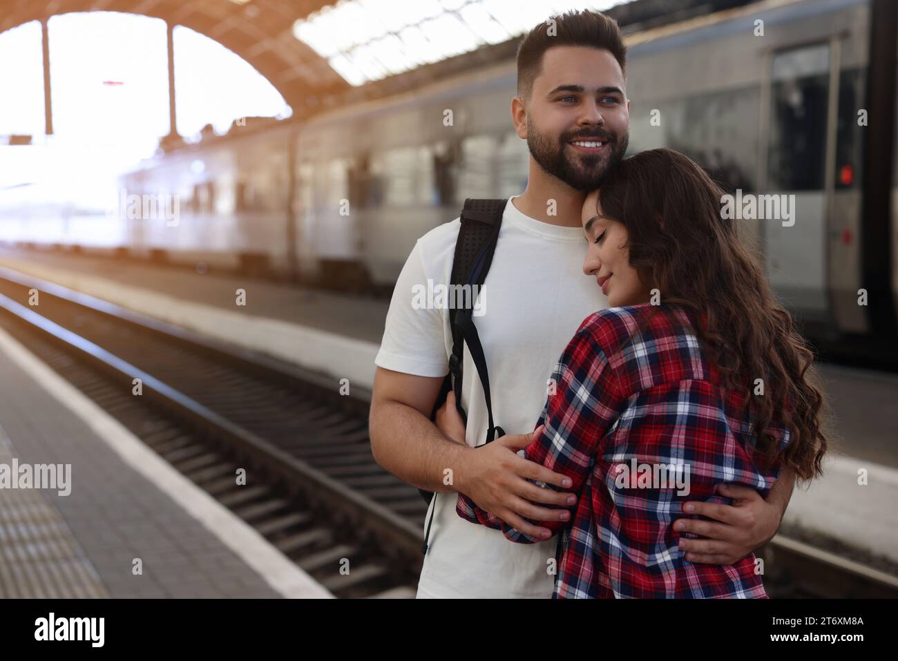 Long-distance relationship. Beautiful couple hugging on platform of ...