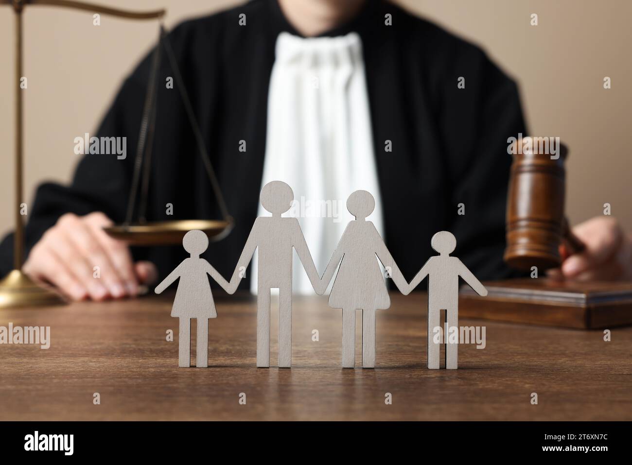 Family law. Judge with gavel and scales of justice sitting at wooden ...