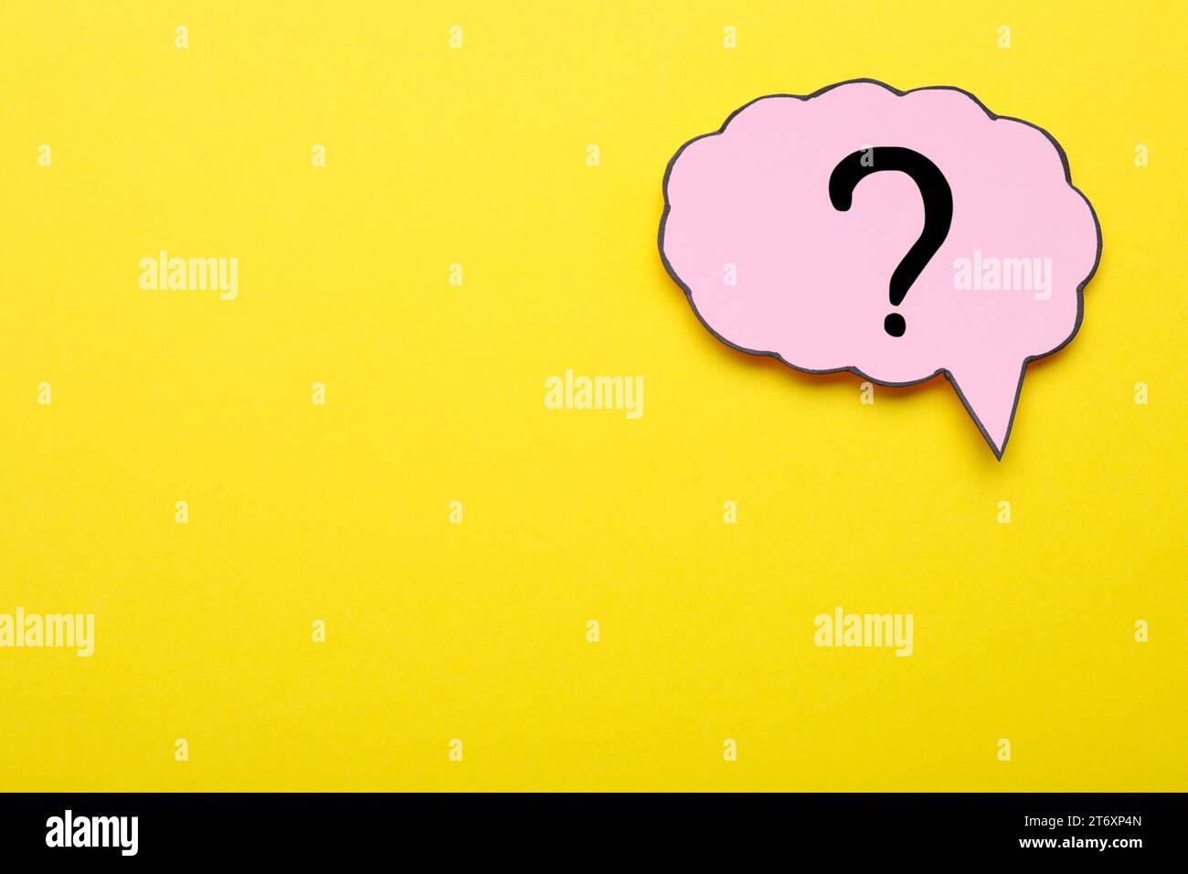 Paper speech bubble with question mark on yellow background, top view ...