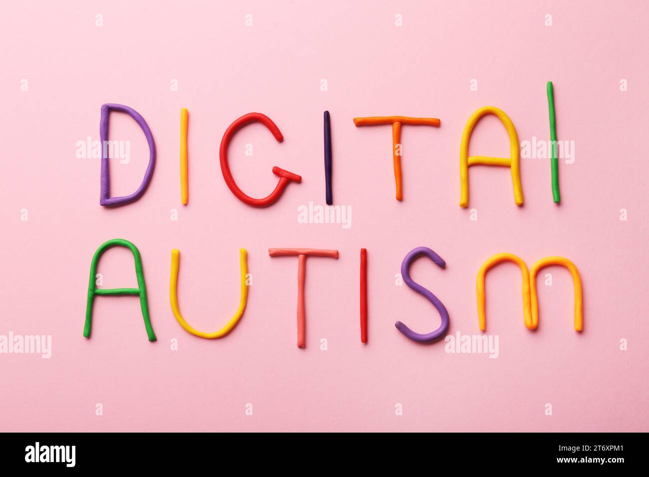 Phrase Digital Autism made of colorful plasticine on pink background ...