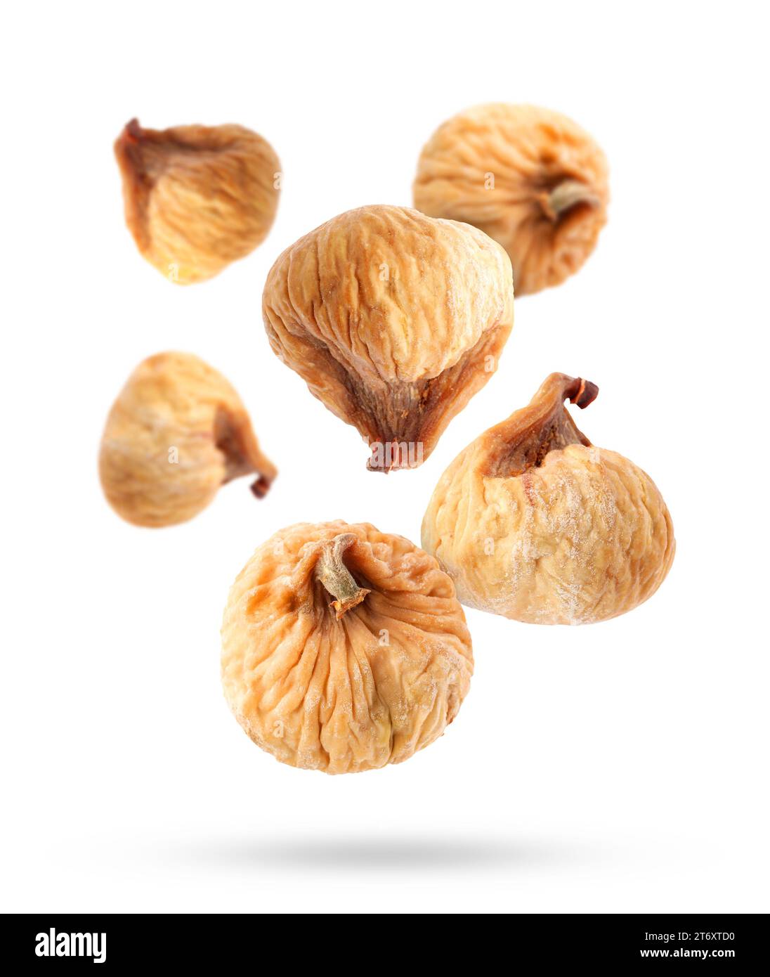 Many dried figs falling on white background Stock Photo - Alamy