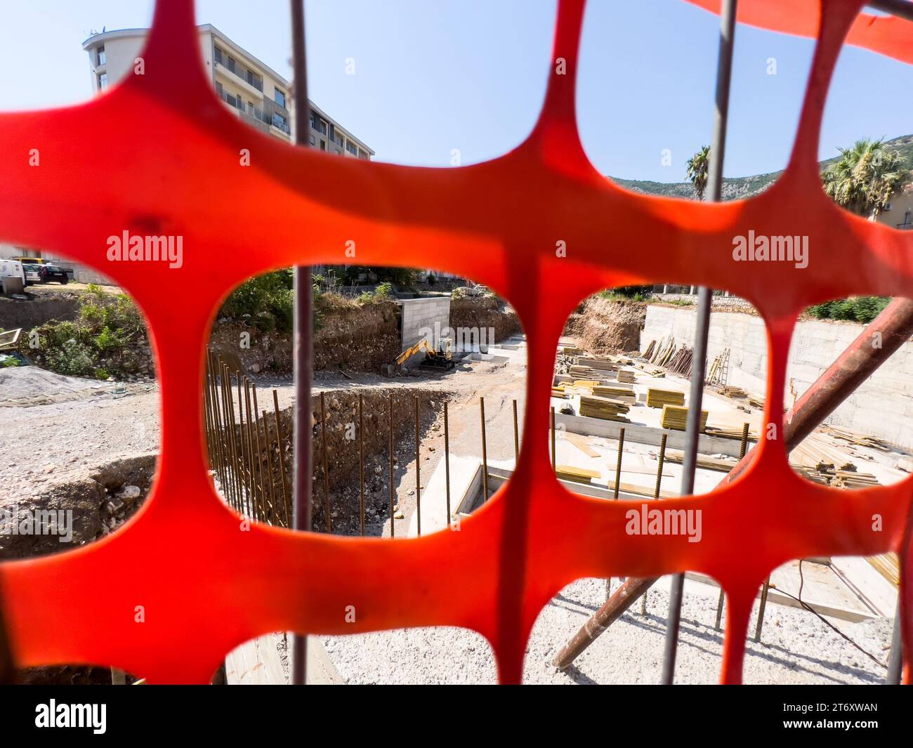 View through the signal grid on the excavator digging the ground at the ...